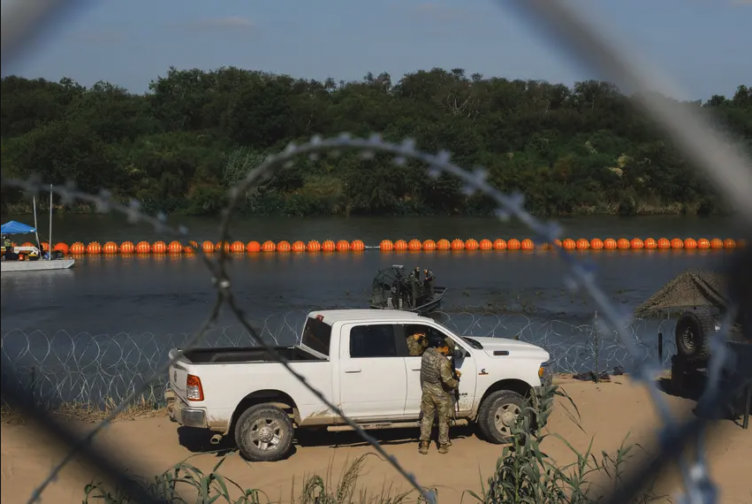 Texas state troopers ordered to push immigrants into river lined with ...